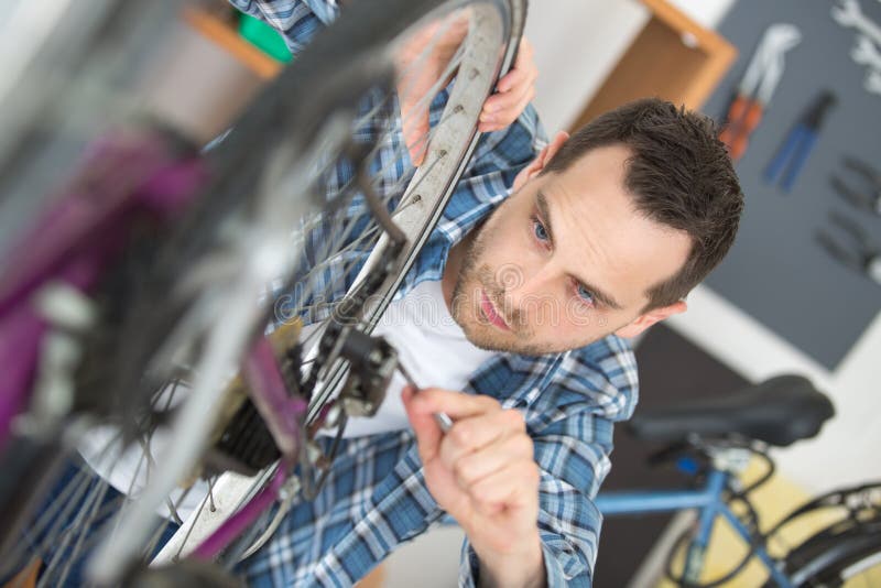 Man mending bikes gear stock image. Image of bicycle - 102045857