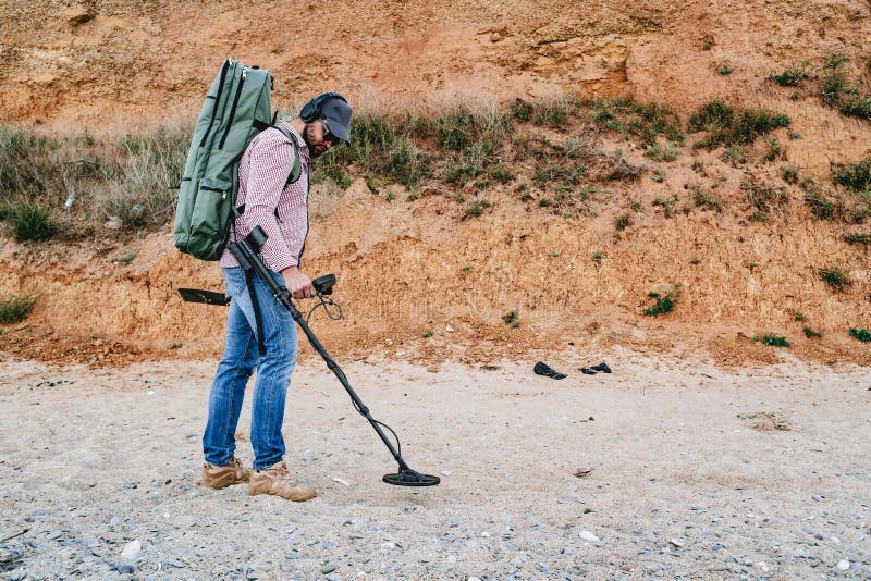 Man with Metal Detector Equipment Searching for Metal Goods in the ...
