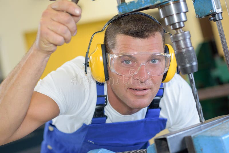 Man metal drilling work stock photo. Image of safeve - 291571354