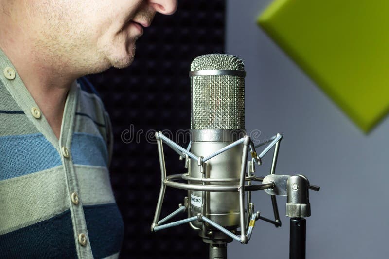 A Man at a Microphone in a Recording Studio. Musical Creativity Stock ...