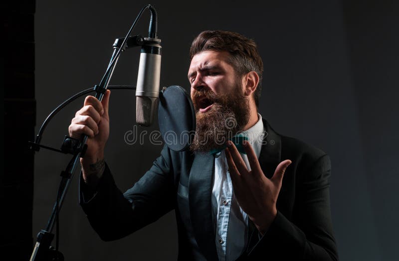Man with Microphone Singing in Music Hall. Stock Image - Image of ...