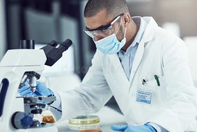 Man, Microscope and Science at Lab for Study, Ppe and Blood Sample for ...