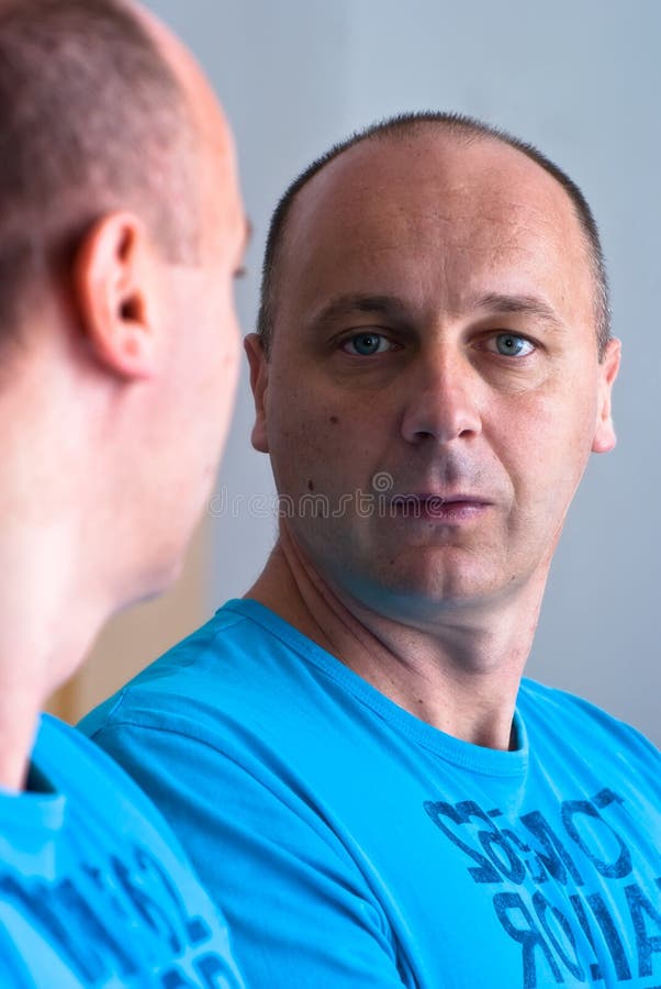 Man Looking in Mirror stock photo. Image of indoors, facial - 622194