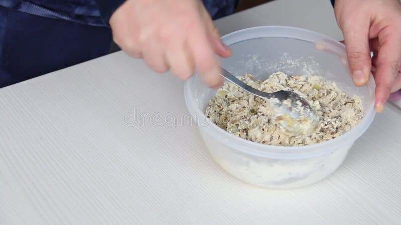 A Man Mixes Ingredients for a Multi-cereal Loaf in a Container. on a ...