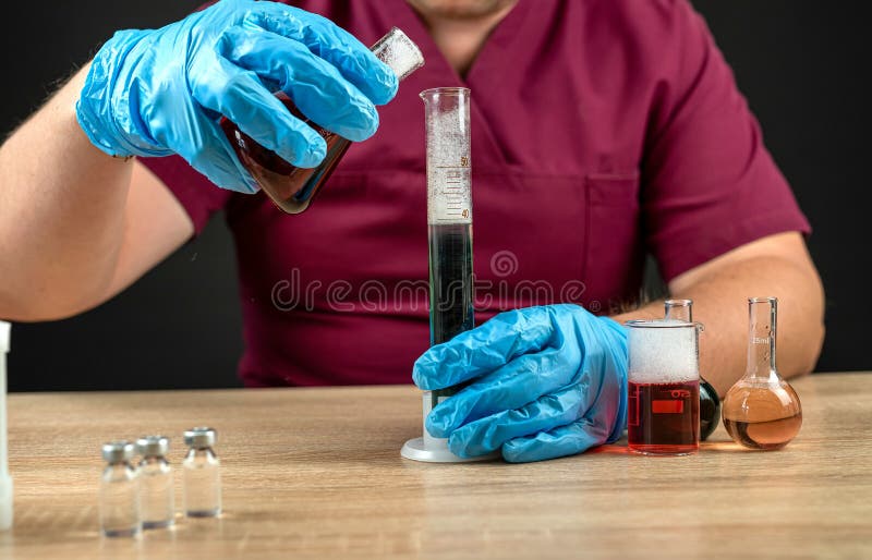 A Man Mixes a Liquid in Test Tubes in a Laboratory Stock Photo - Image ...