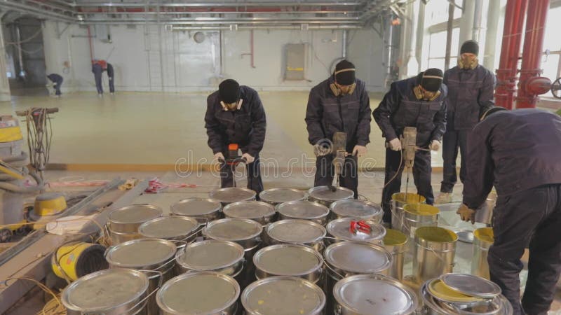 A Worker is Stirring a Self-leveling Floor in a Bucket. the Man Mixes ...