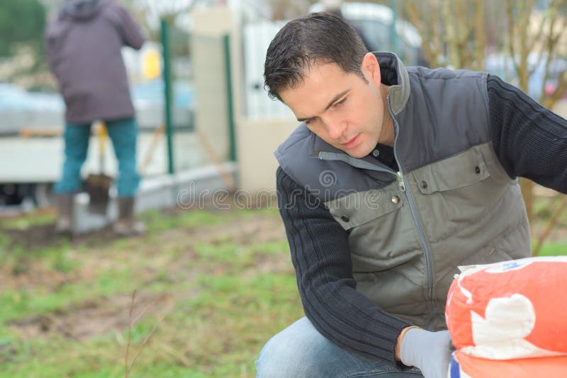 Man mixing cement stock photo. Image of vocational, fence - 261157060