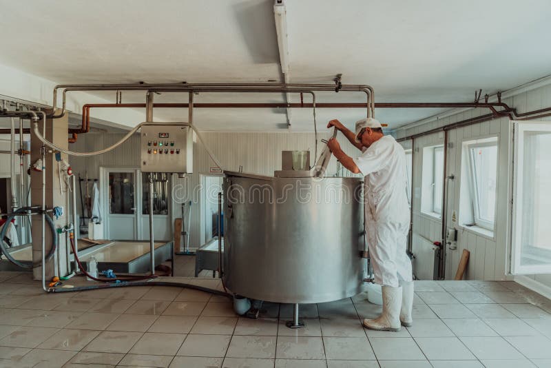Man Mixing Milk in the Stainless Tank during the Fermentation Process ...