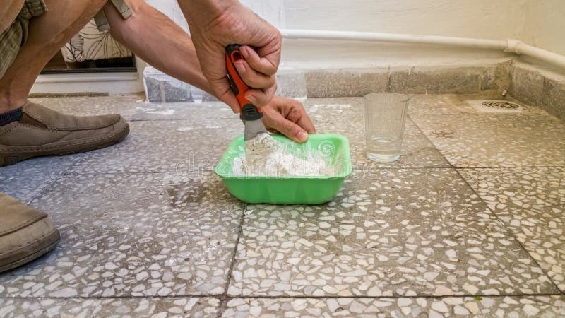 Man Mixing Plaster Powder with Water in Polystyrene Container with ...