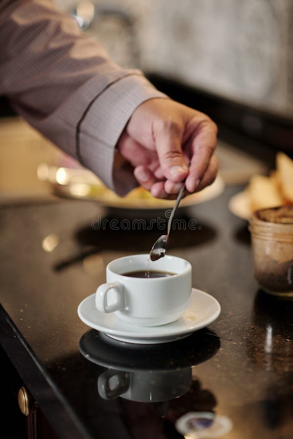 Man Mixing Sugar in Coffee stock photo. Image of temperature - 263840500