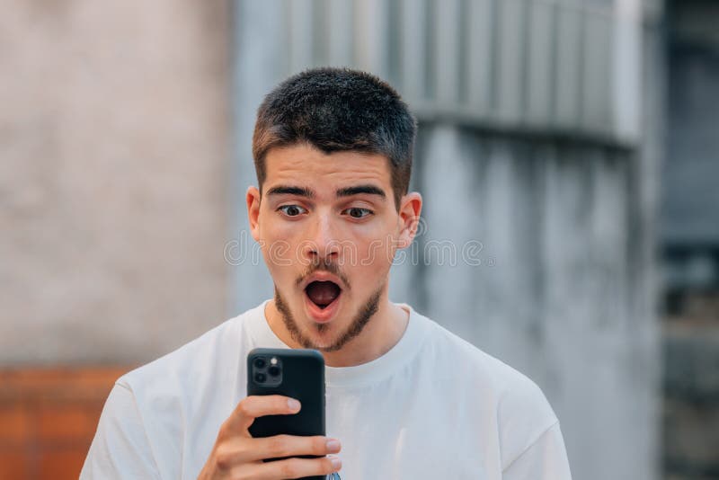 Man with Mobile Phone and Expression of Surprise and Amazement in the ...