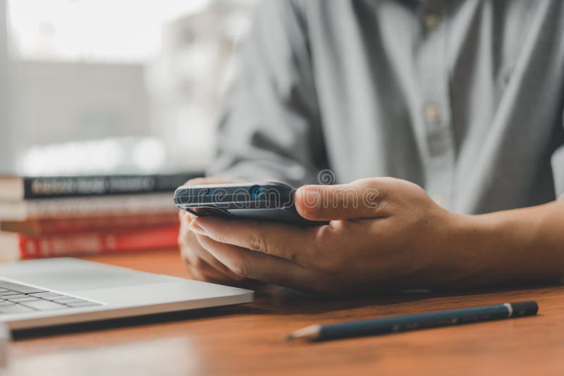 Man with Mobile Phone and Laptop in Office. Freelancer at Work Stock ...