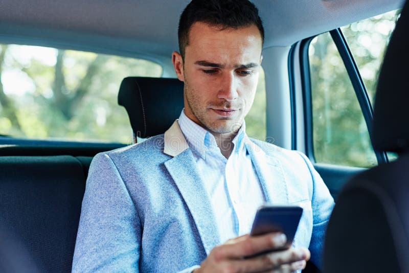 Man with Mobile Phone Sitting in Car and Typing Text Message Stock ...