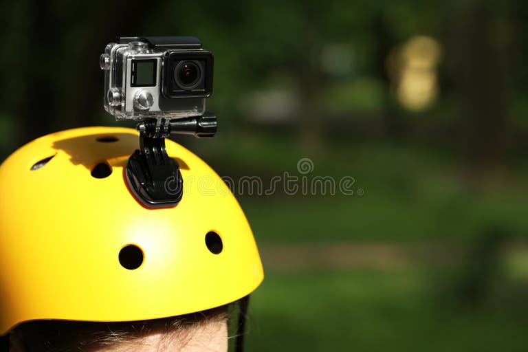 Man with Modern Action Camera on Helmet Outdoors, Closeup. Space for ...