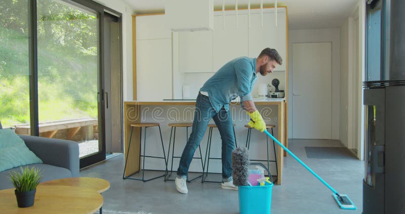 Man is Mopping Floor at Home and Having Fun. Man, Joy and Houses ...