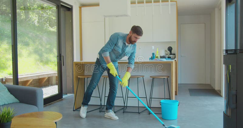 Man is Mopping Floor at Home and Having Fun. Man, Joy and Houses ...