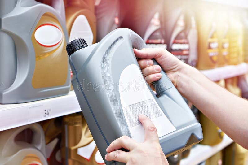 Man with Motor Oil in Store Stock Image - Image of mechanic, motor ...