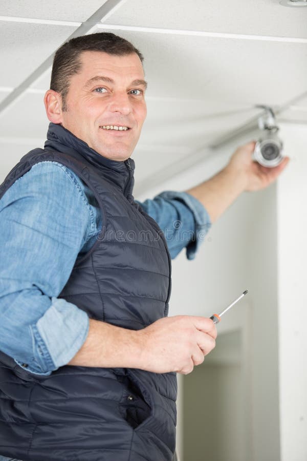 Man Mounting Security Camera To Ceiling Stock Photo - Image of mounting ...