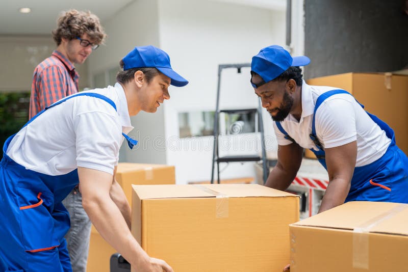 Man Movers Worker in Blue Uniform Unloading Cardboard Boxes from Truck ...