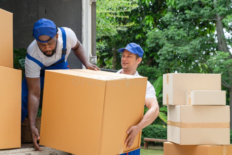Man Movers Worker in Blue Uniform Unloading Cardboard Boxes from Truck ...