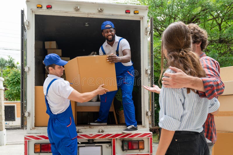 Man Movers Worker in Blue Uniform Unloading Cardboard Boxes from Truck ...