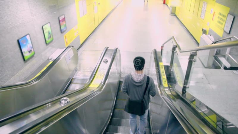 Man Moves Down on Escalator, Shown in Motion from Stock Footage - Video ...