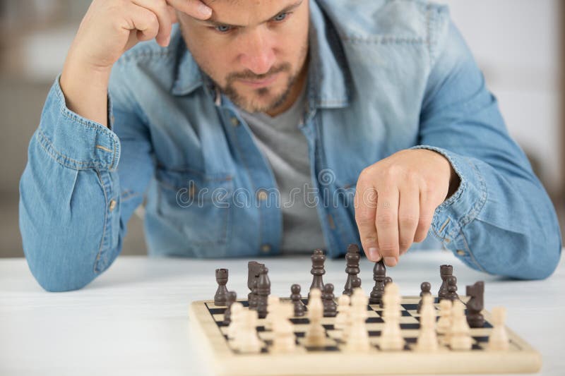 Man moving chess piece stock photo. Image of concentration - 270024588