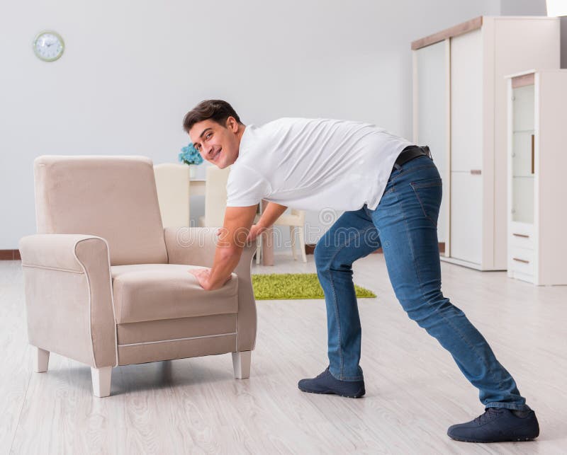 Man Moving Furniture at Home Stock Image - Image of casual, house ...