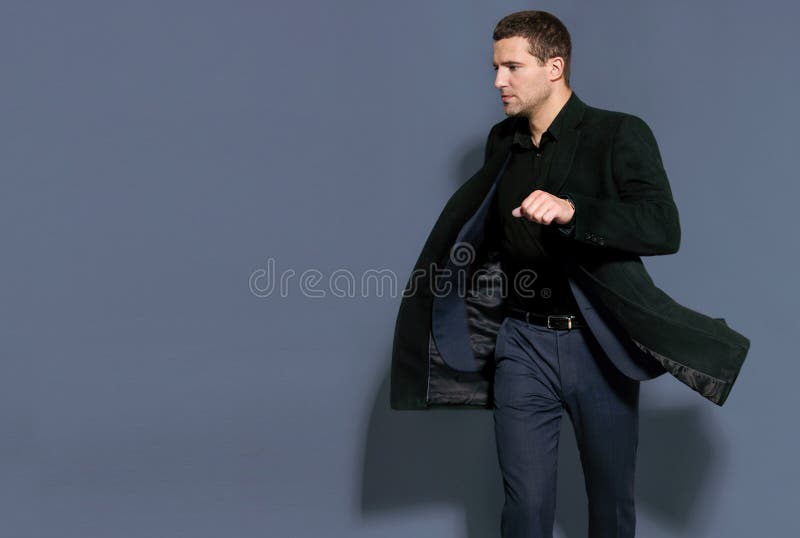 Man in a Black Coat on a Gray Background Studio Stock Image - Image of ...