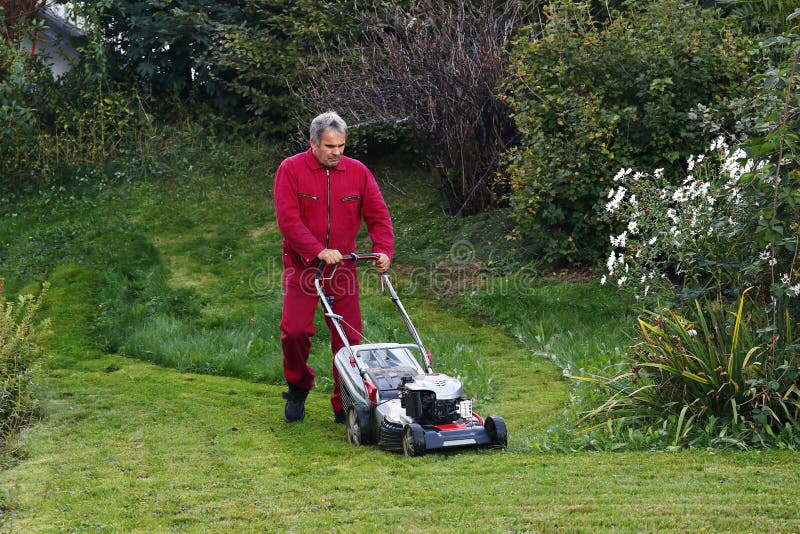 A man mowing the lawn stock image. Image of cutting - 128175653