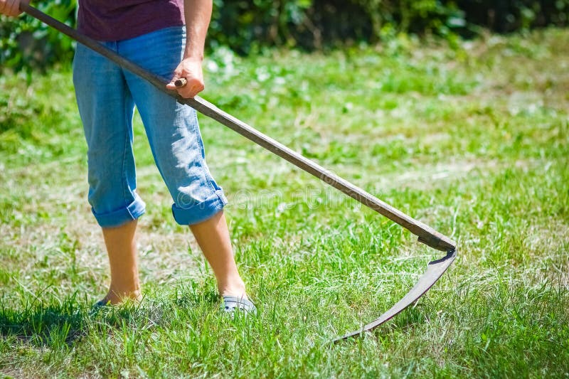 Man mows grass with scythe stock photo. Image of landscape - 334720910