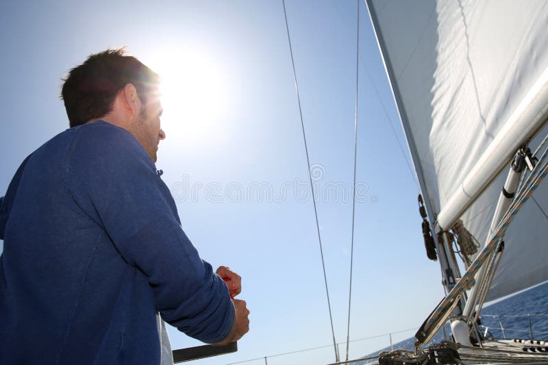 Man Navigating Boat with Sails Stock Image - Image of single, cruising ...