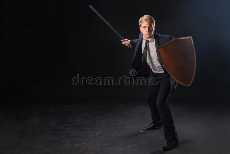 Man in a Navy Suit Stands Poised with a Sword and Shield Stock Image ...