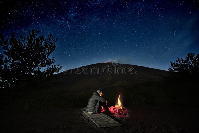 Man Near Campfire Under Etna Volcano and Starry Sky, Sicily Stock Photo ...