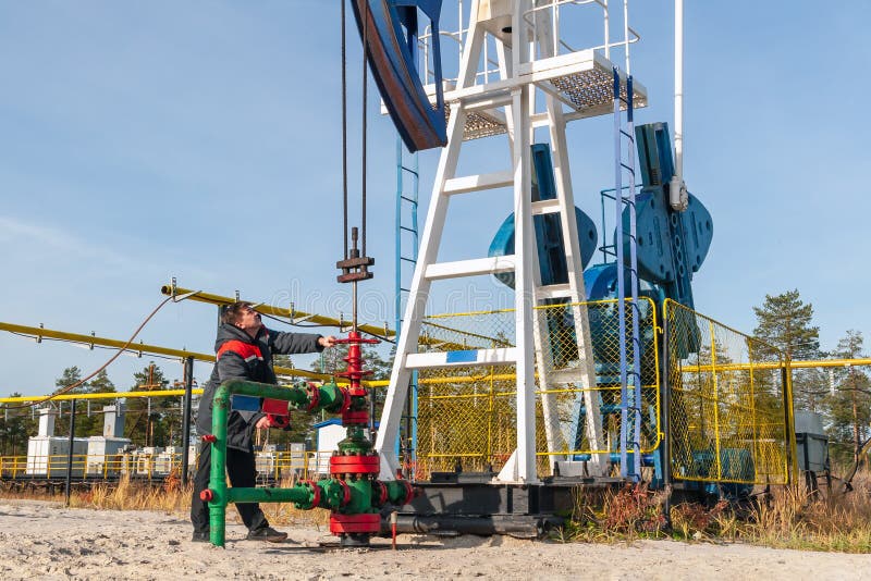 A Man Near the Oil Pump. Oil, Gas Industry. a Man Controls the Process ...