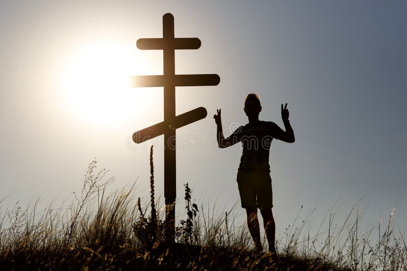 Man Near Orthodox Cross on the Background of the Sunset Stock Photo ...