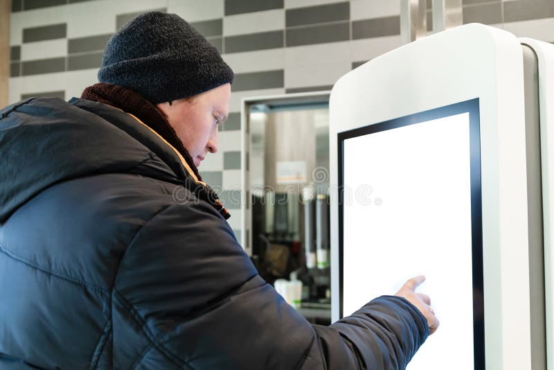 A Man Near Self Service Restaurant, Kiosk, Terminal with Empty Screen ...