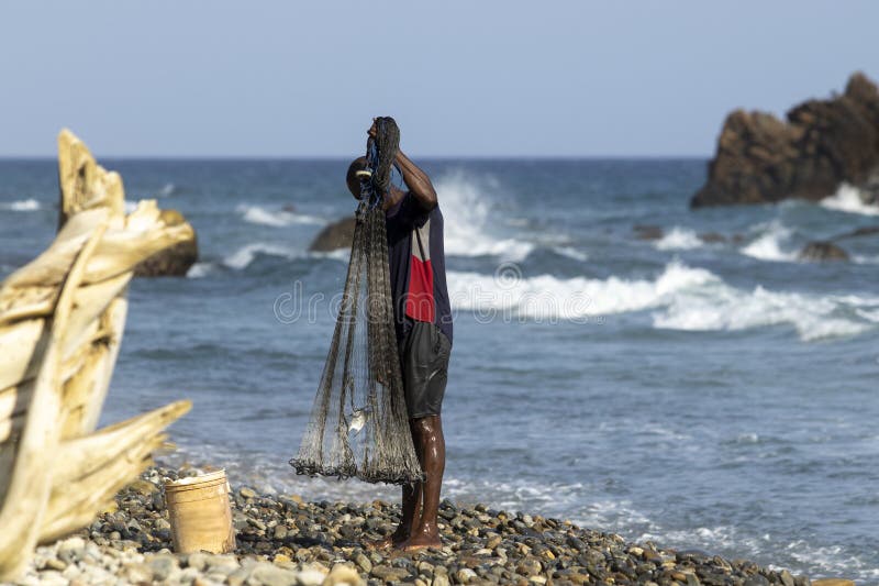 Man Standing on Beach by Shore and Holding Net in His Hands Stock Image ...