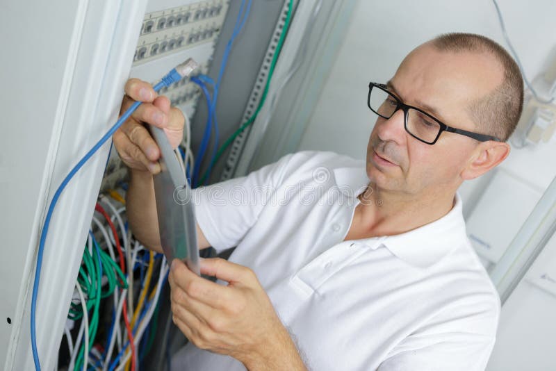 Man in network server room stock photo. Image of server - 188229280