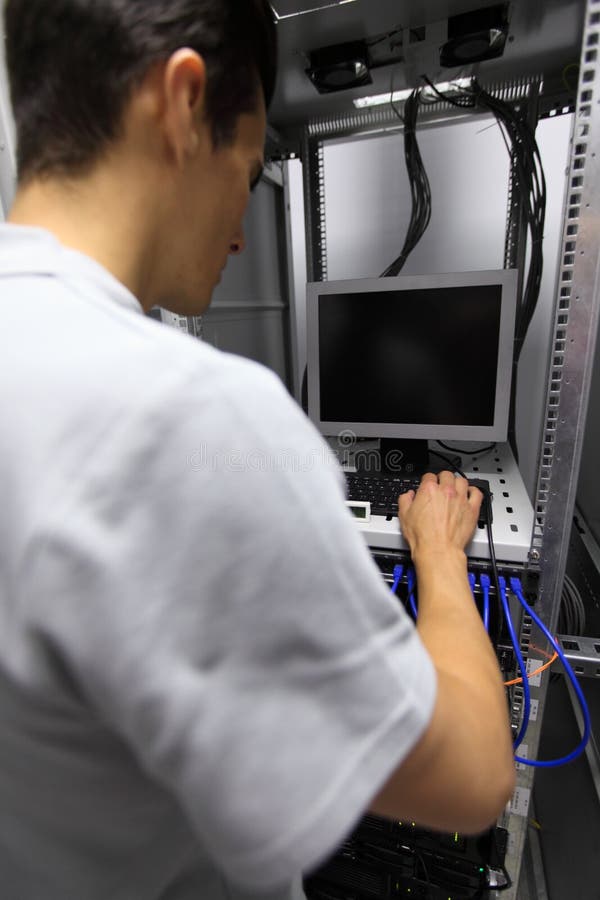 Man in network server room stock photo. Image of datacenter - 77846654