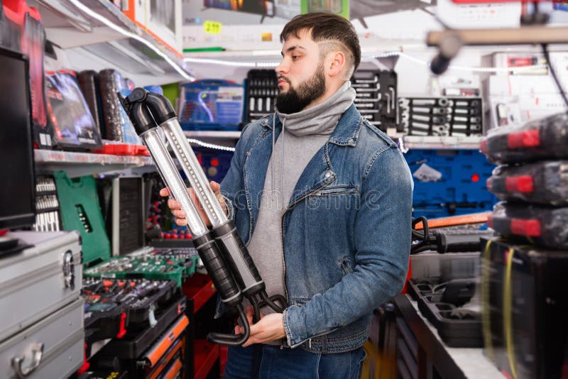 Man with New Portable LED Lamp in Hardware Store Stock Photo - Image of ...