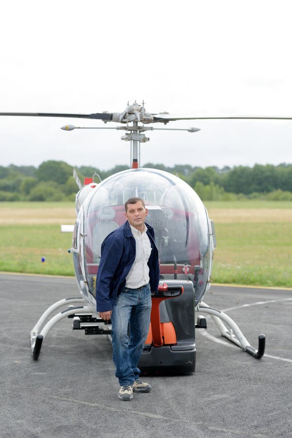 Man next to helicopter stock photo. Image of curve, west - 248310850