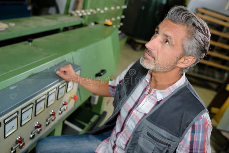Man Next To Machine Overseeing Production Stock Photo - Image of worker ...