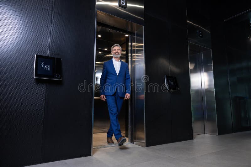 Man in a Nice Elegant Suit Going Out of the Elevator in the Business ...
