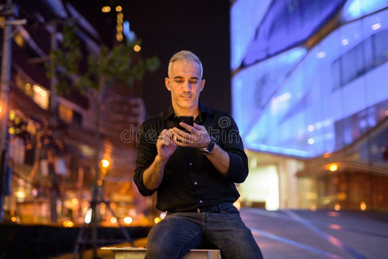 Man at Night on the Streets Using Mobile Phone Stock Photo - Image of ...