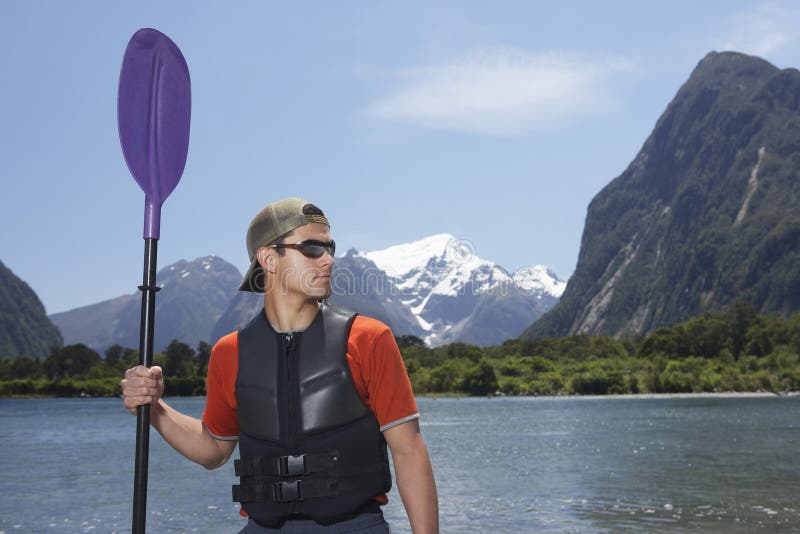 Man with Oar in Front of Mountain Lake Stock Photo - Image of outdoors ...