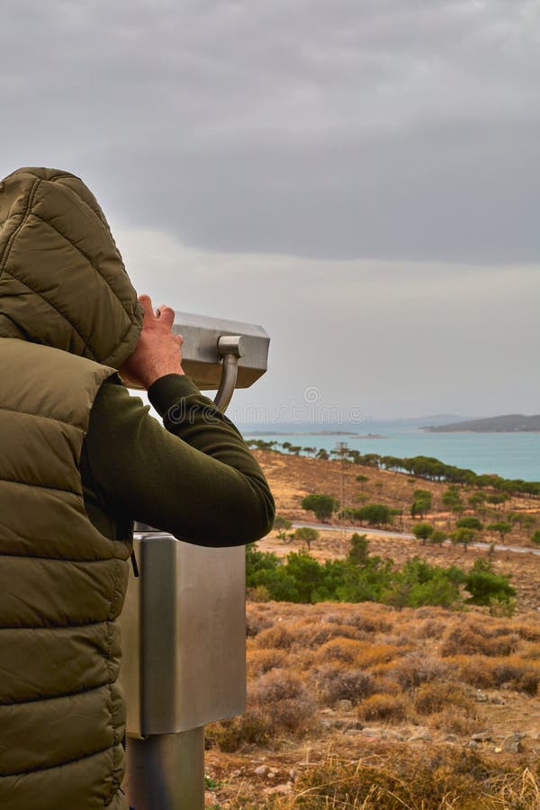 A Man on an Observation Deck Looks through a Telescope Stock Image ...