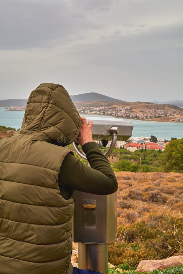 A Man on an Observation Deck Looks through a Telescope Stock Photo ...