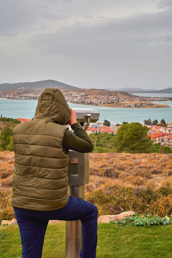 A Man on an Observation Deck Looks through a Telescope Stock Image ...