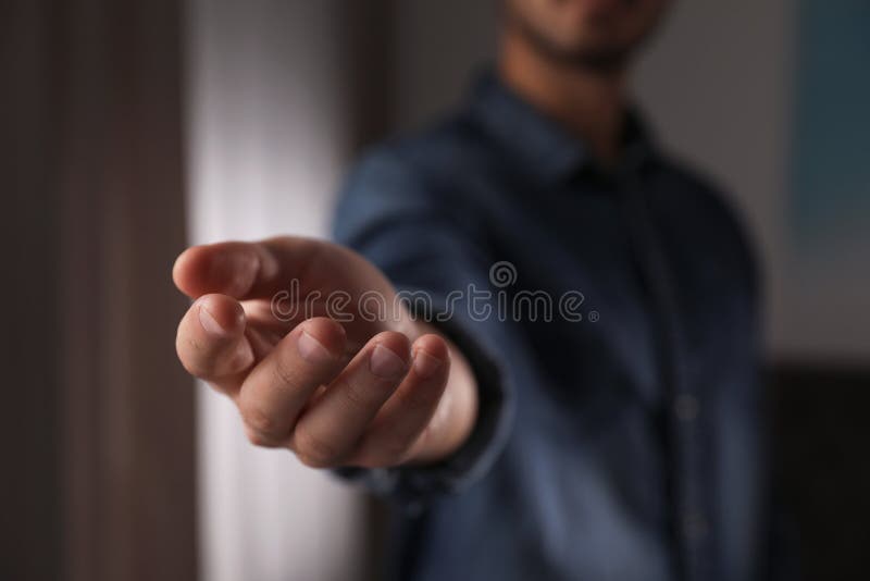 Man Offering Helping Hand on Blurred Background Stock Photo - Image of ...